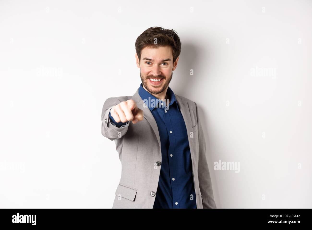 Its you. Smiling handsome manager in suit pointing at camera, choosing ...