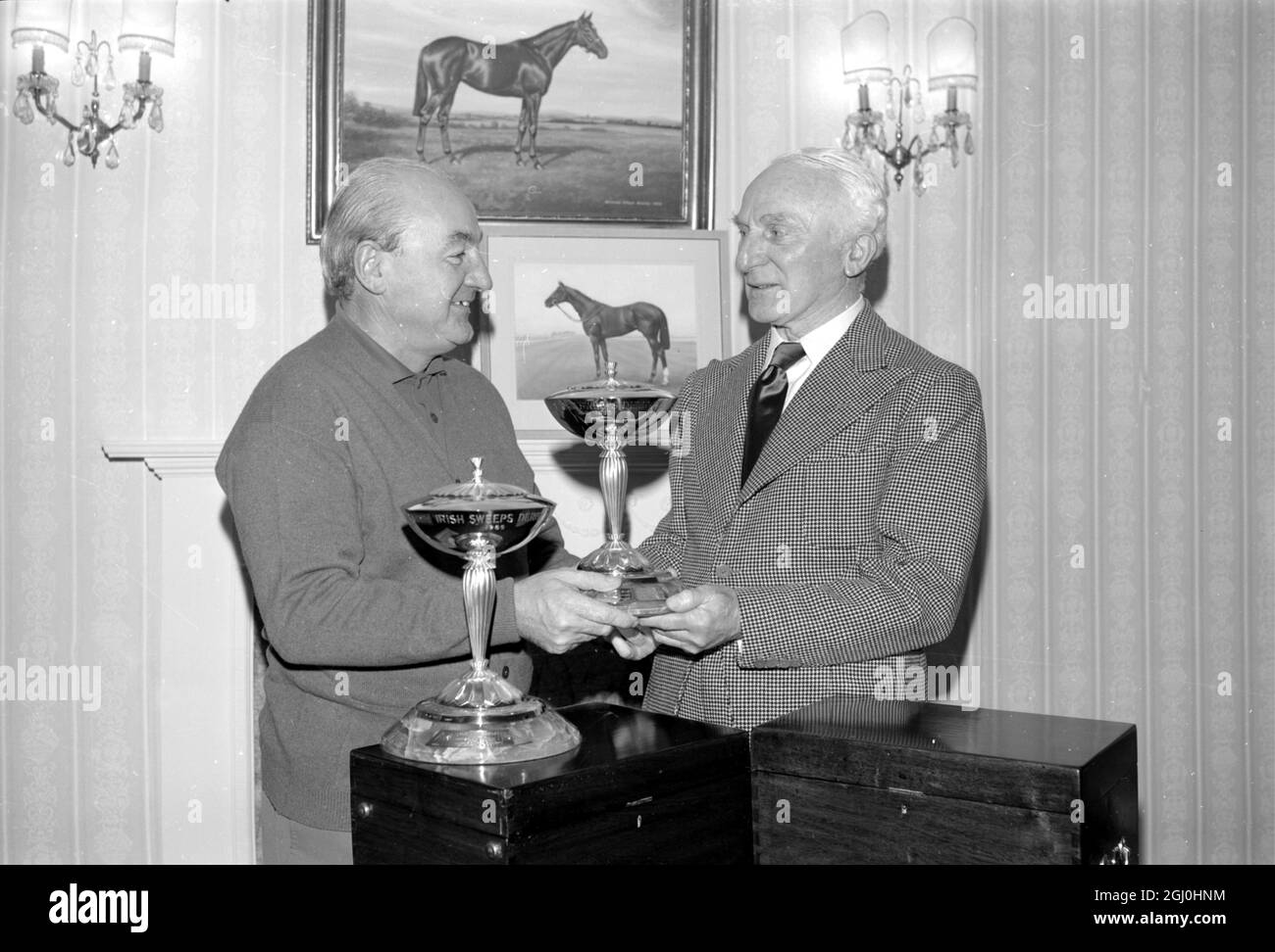 Captain Spencer Freeman ( right ) is seen handing over the two gold ...