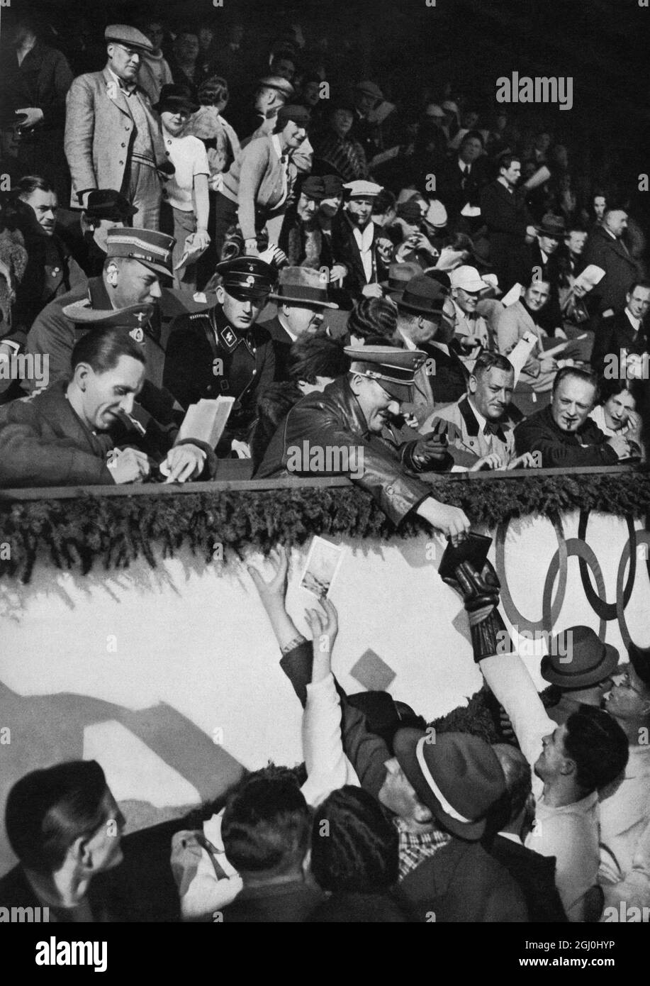The Fuhrer and German Chancellor, Adolf Hitler giving autographs to the ...