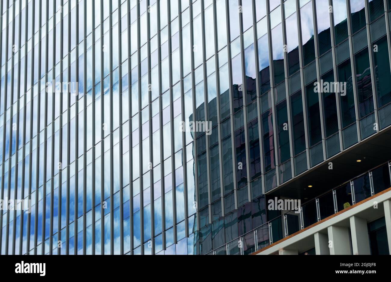 Sky reflected on the mirrored glass facade of a modern building Stock ...