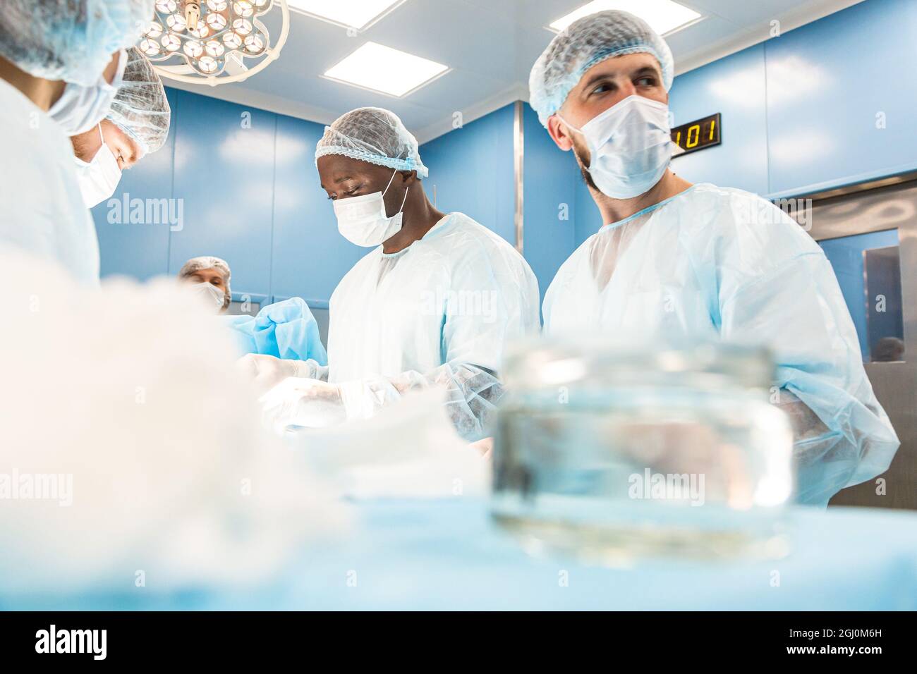 An international team of doctors performs a complex surgical operation ...