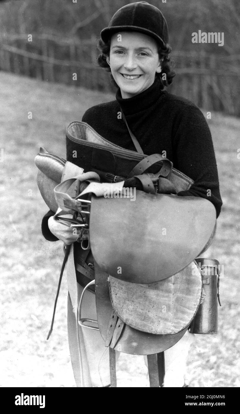 Young lady rider with tack draped over her arm Stock Photo - Alamy