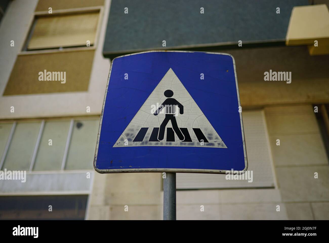 Low angle shot of a blue pedestrian crossing sign Stock Photo - Alamy