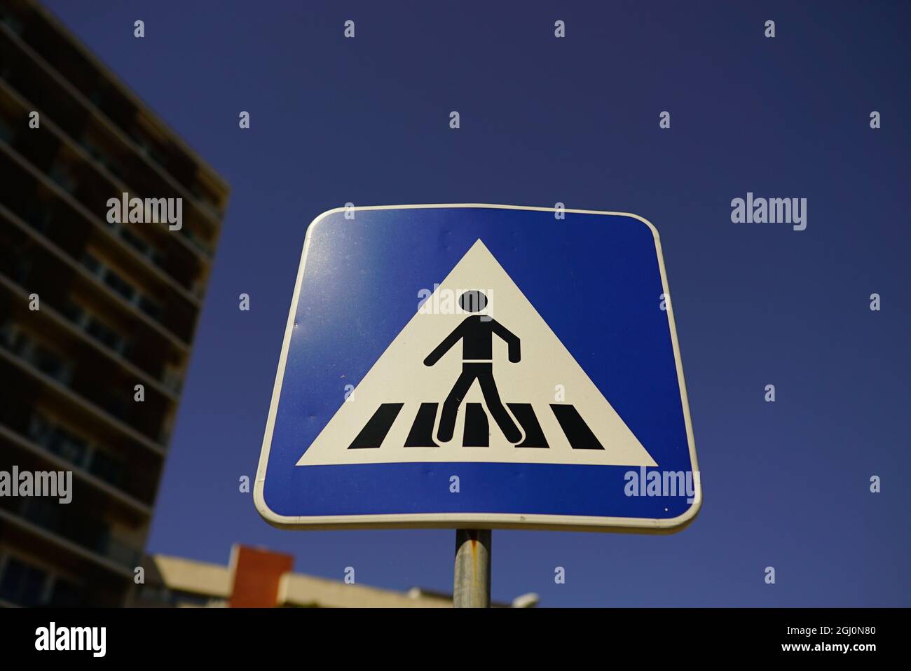 Low angle shot of a blue pedestrian crossing sign Stock Photo - Alamy