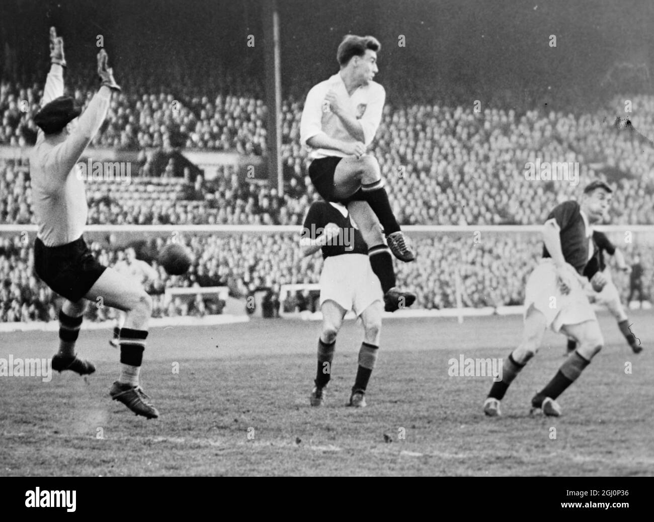 Austria right back Halla clears from between Lawrie Reilly and Cowie of ...