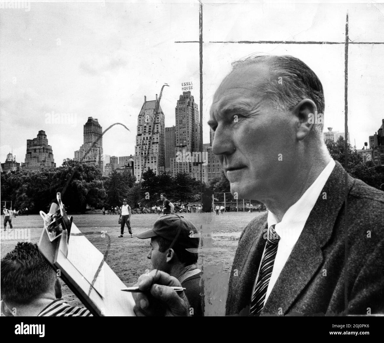 Former New York Yankees pitcher Red Ruffing jots down some notes as he ...