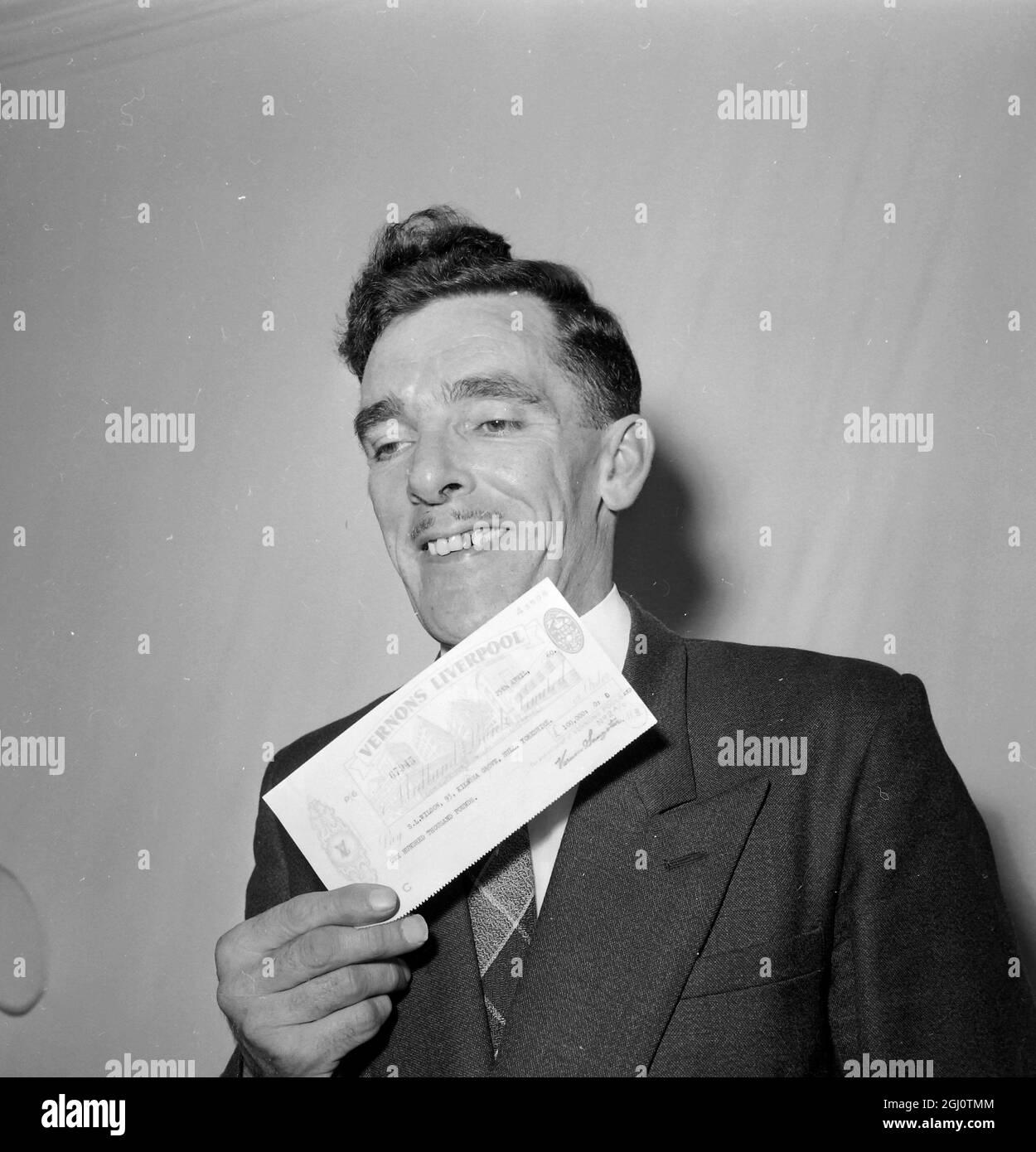 FOOTBALL POOLS WINNERS MR STANLEY WILSON WAVES CHEQUE £100000 26 APRIL ...