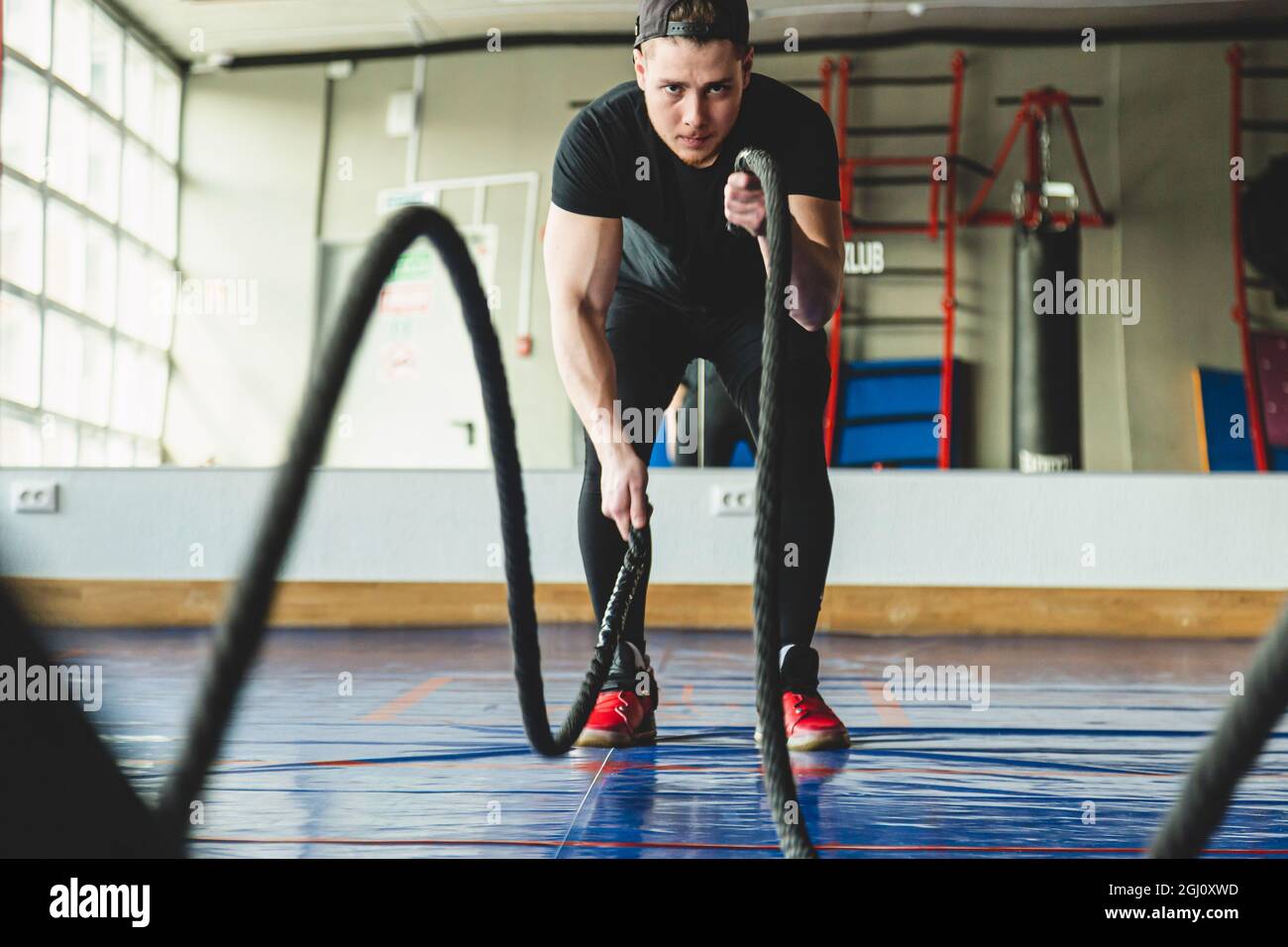 Muscular man in the gym with ropes doing exercises. Crossfit Stock ...