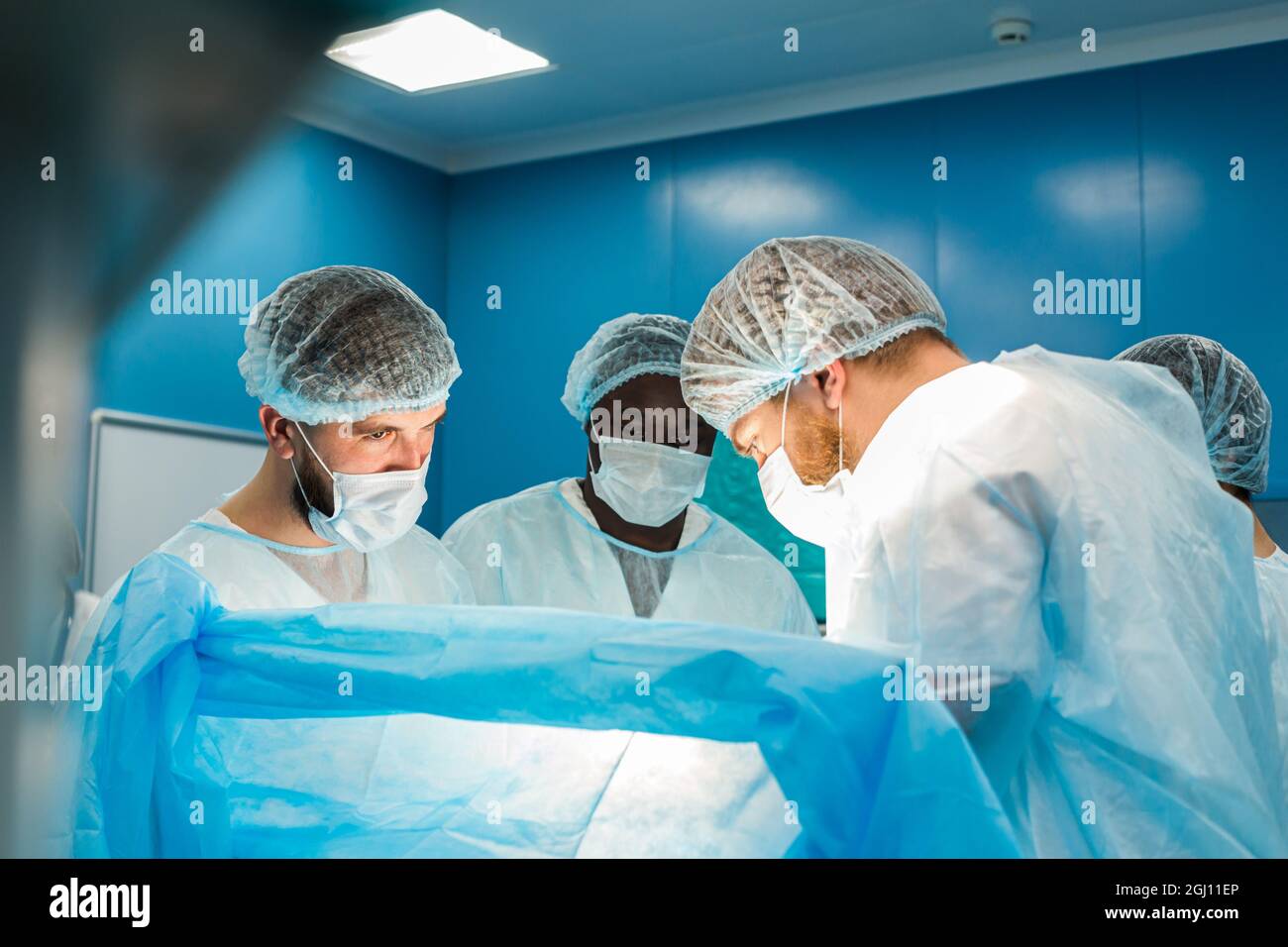 An international team of doctors performs a complex surgical operation ...