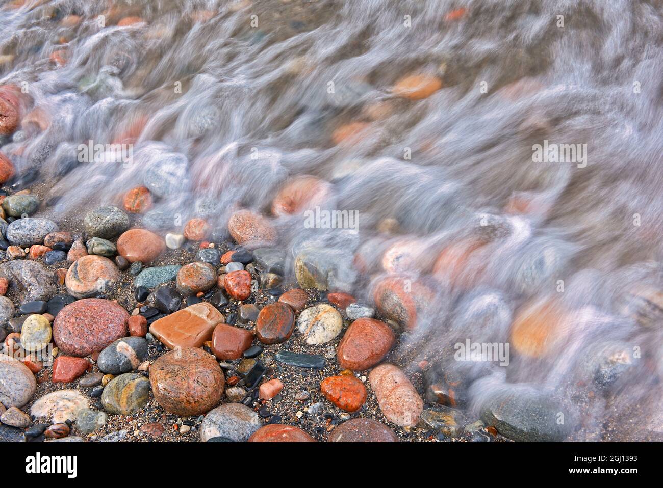 Canada, Ontario, Marathon. Rocks and driftwood on Pebble Lake Superior ...