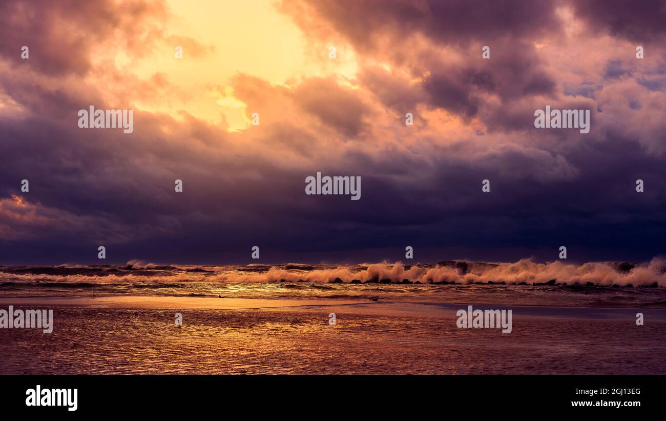 The setting sun among cloud storms. Changing weather conditions from a ...