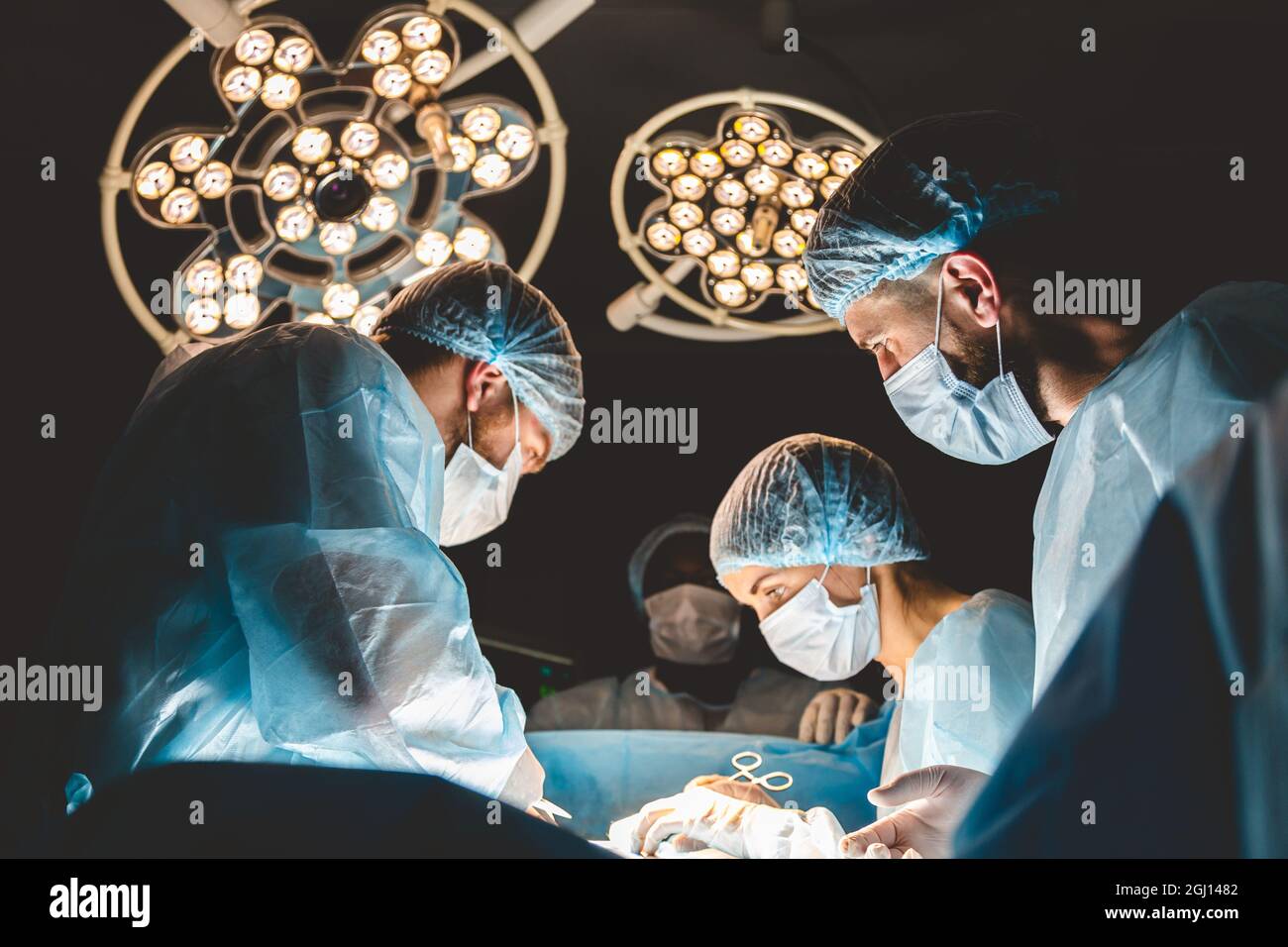 An international team of doctors performs a complex surgical operation ...