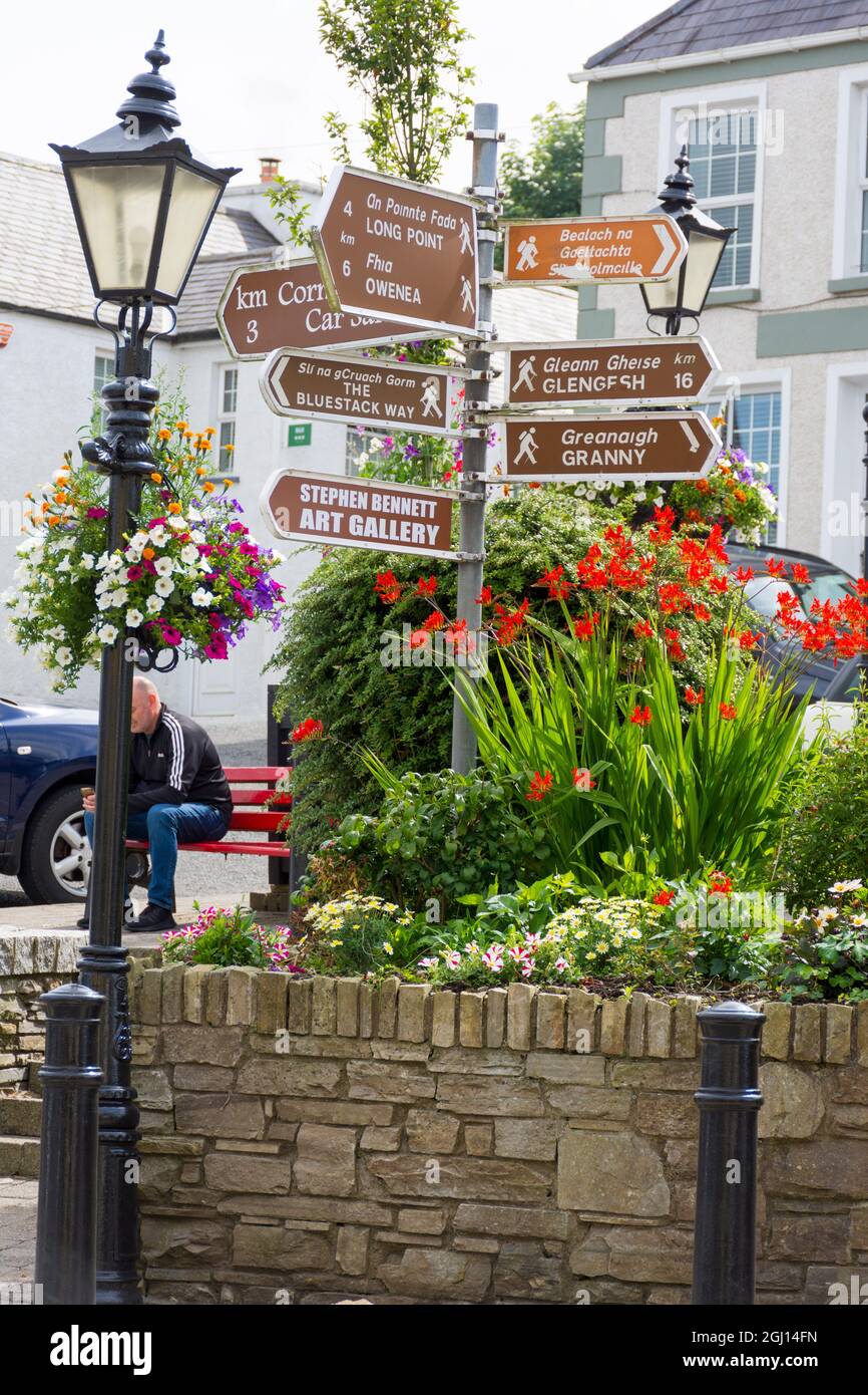 Signpost and flowers in centre of village. Ardara, County Donegal ...