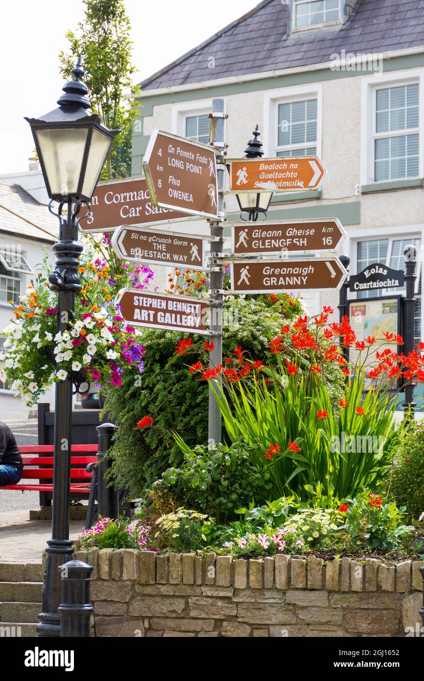 Signpost and flowers in centre of village. Ardara, County Donegal ...
