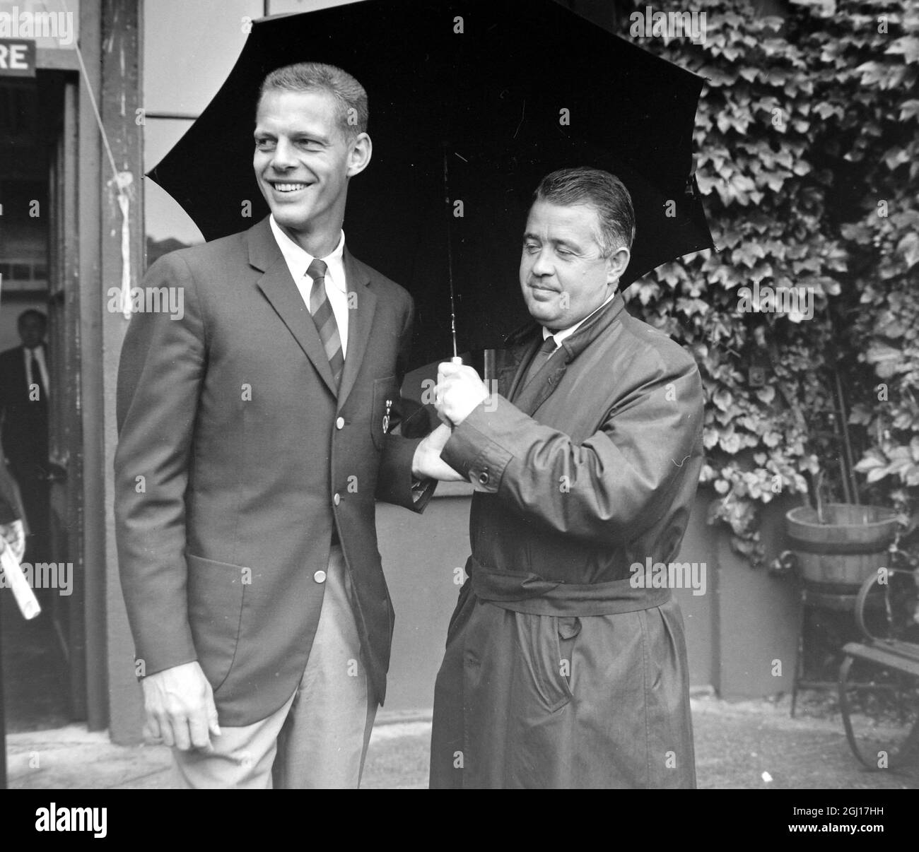 TORSTEN JOAHNSEN WITH TENNIS PLAYER ULF SCHMIDT UNDER UMBRELLA AT ...