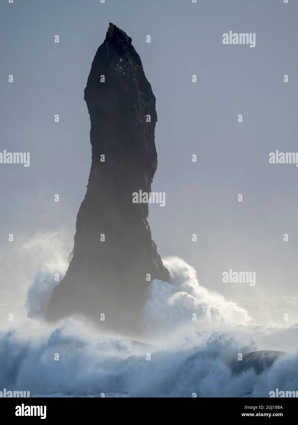 Coast near Vik y Myrdal during winter. The sea stacks Reynisdrangar ...