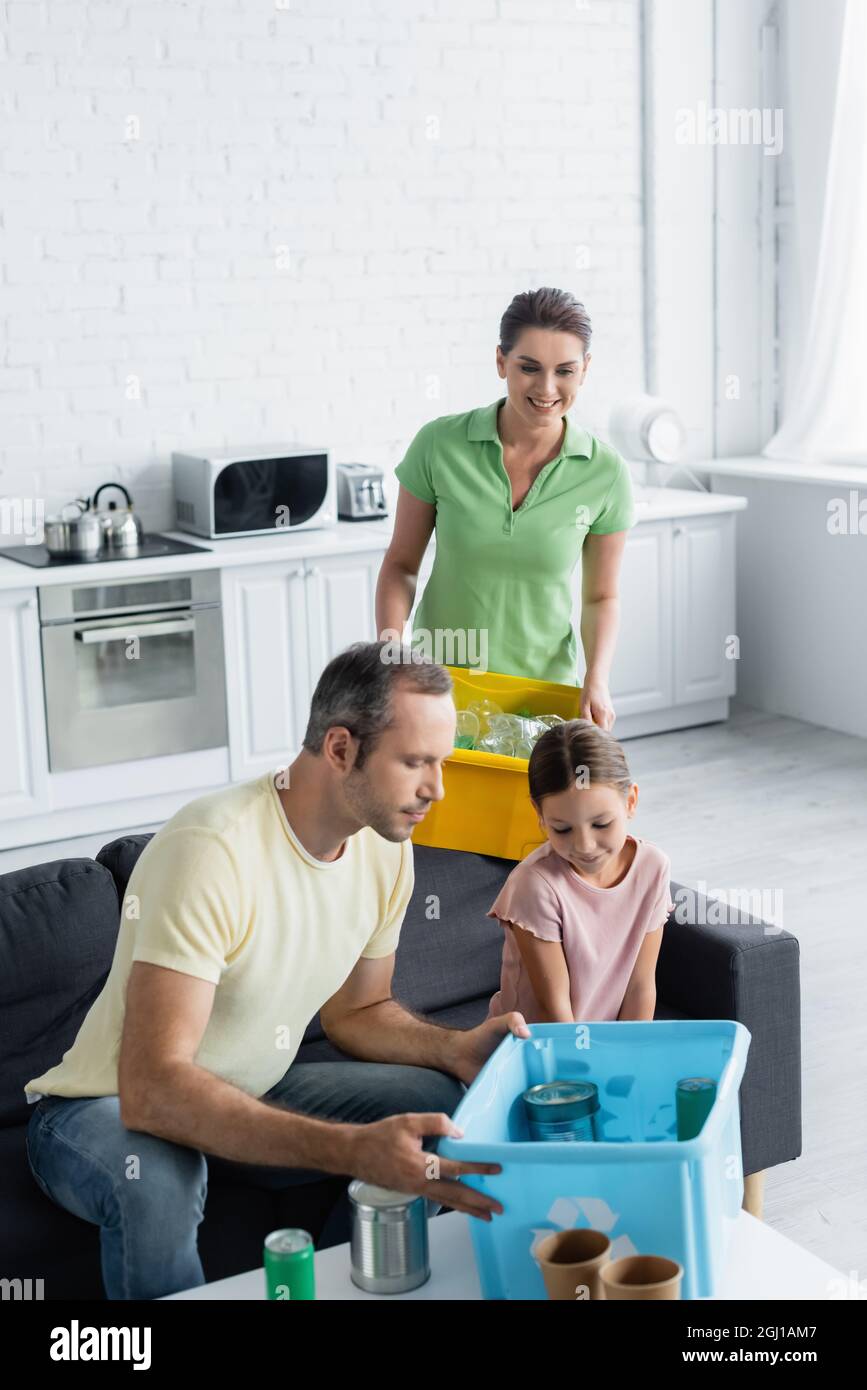 Family sorting garbage near hi-res stock photography and images - Alamy