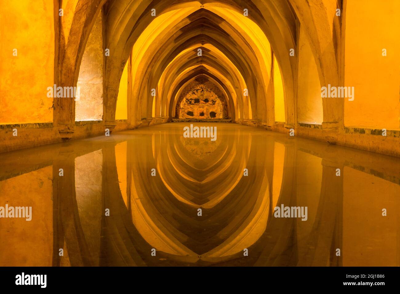 Spain, Andalusia, Seville. The repeating arches of the interior of the ...