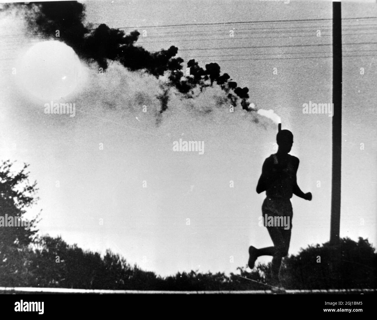 Olympic runner with torch Black and White Stock Photos & Images - Alamy