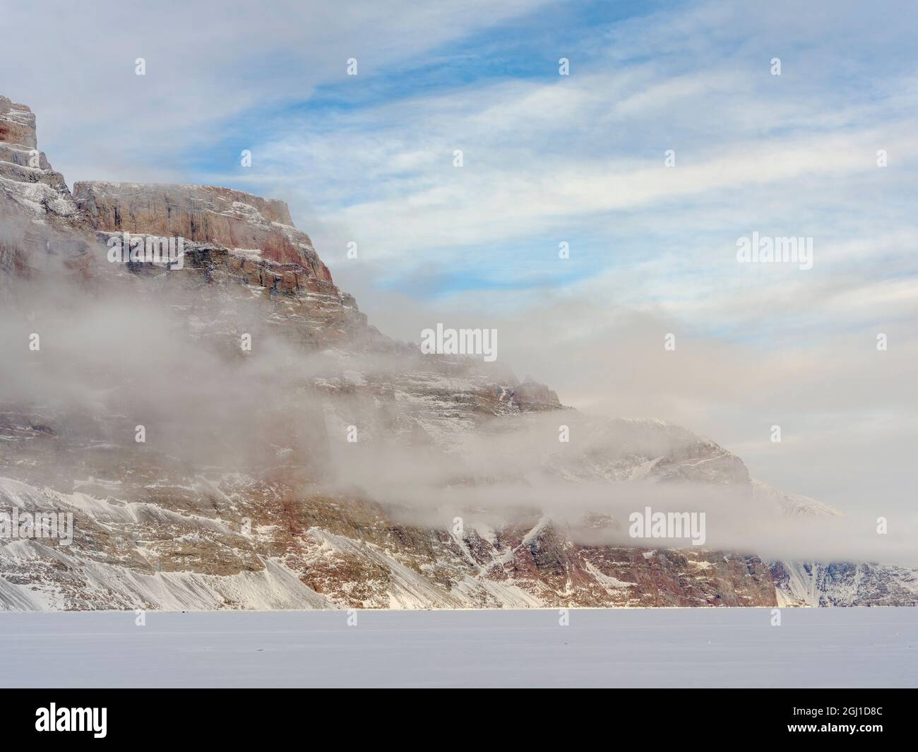 Storen Island, frozen into the sea ice of the Uummannaq fjord system ...