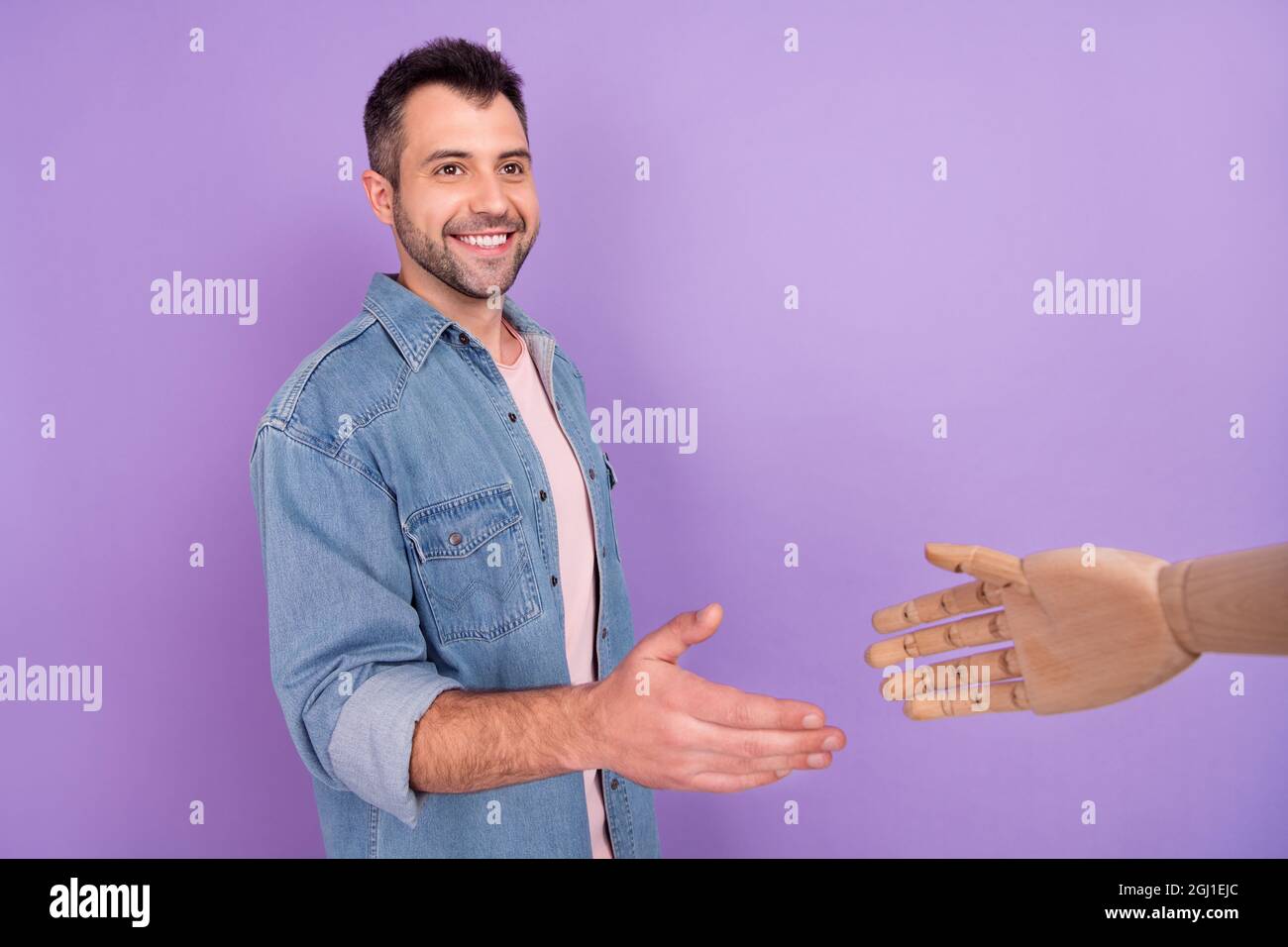 Photo portrait brunet man smiling doing handshake wooden hand isolated ...
