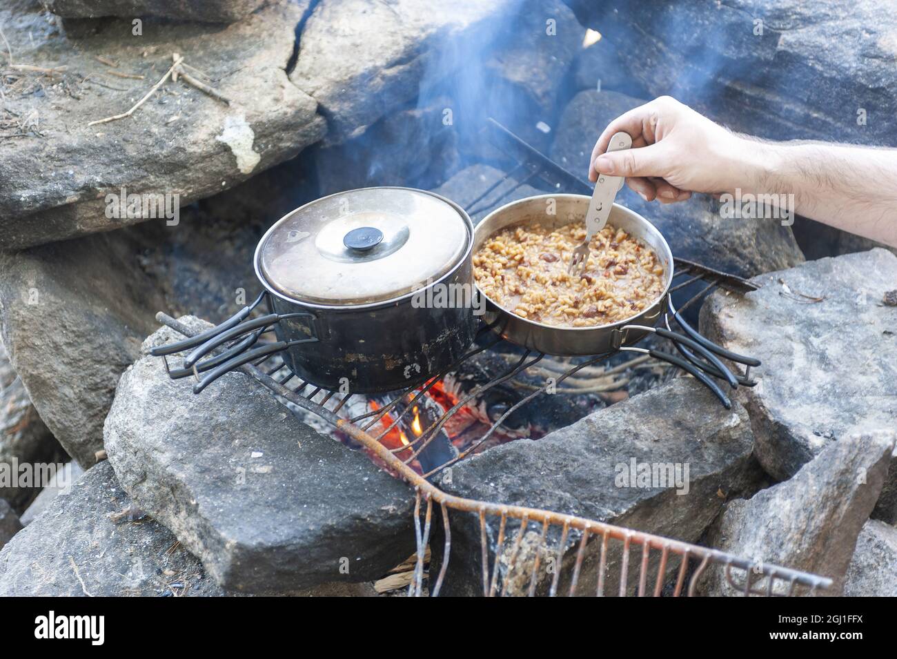 Food cooking over campfire Stock Photo - Alamy