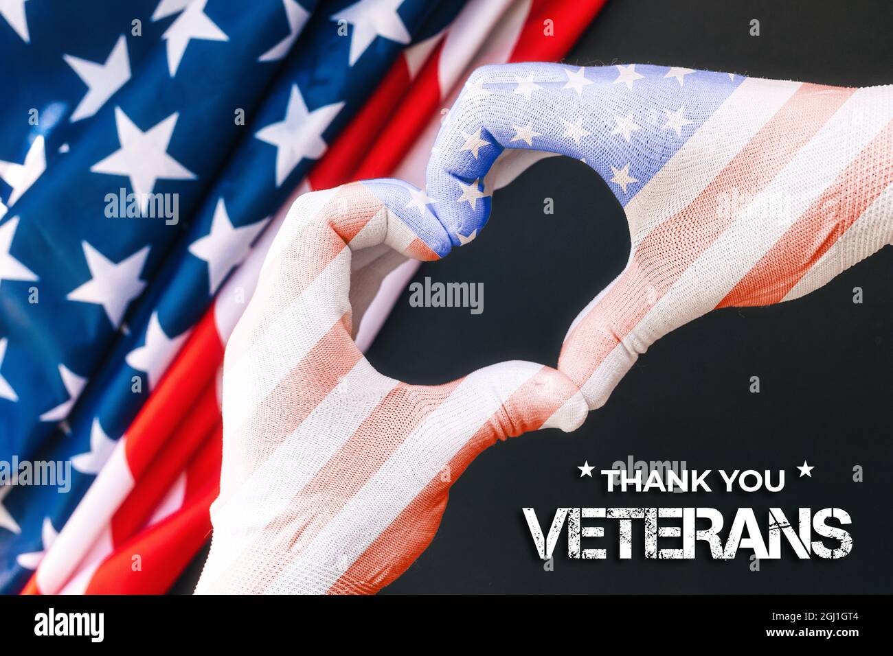 Veterans Day. Man's hands in gloves the color of the American flag ...
