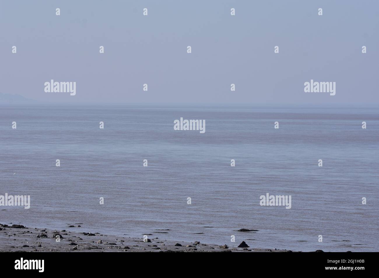 The shore, sea and sky that's all very grey Stock Photo - Alamy