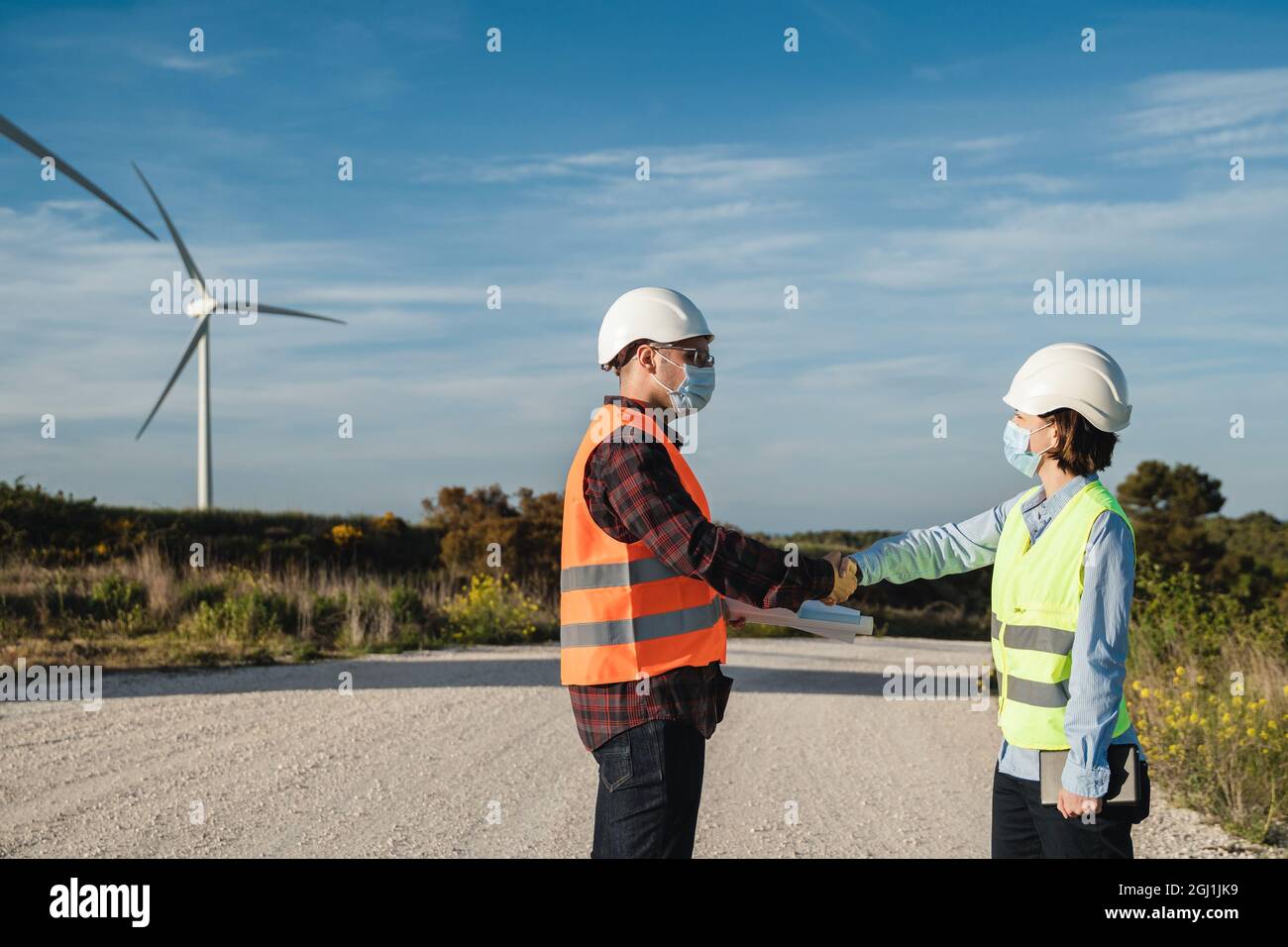 Engineer workers discussing projects at wind alternative energy farm ...
