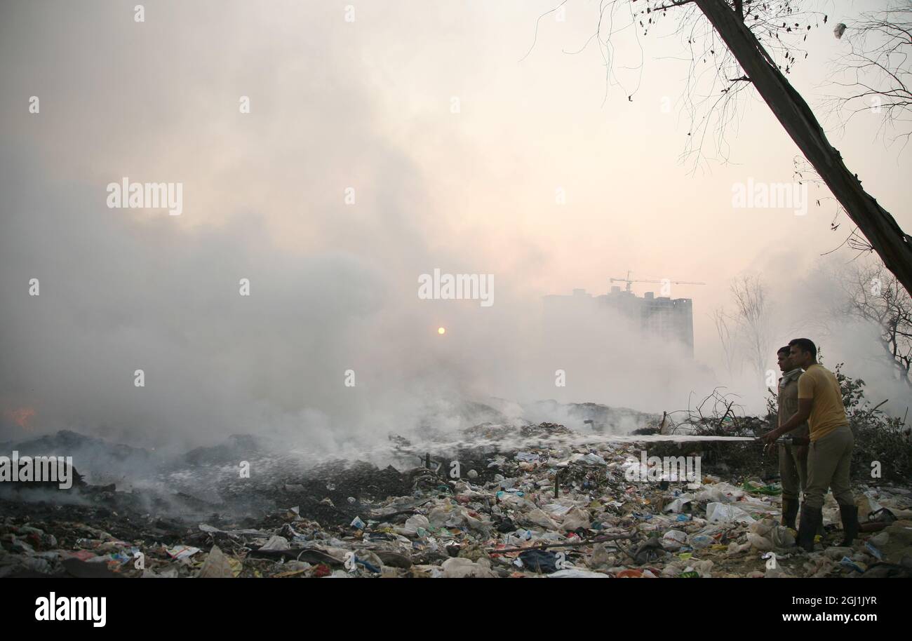 indian fire personnel try to douse the fire at a waste dumping ground ...