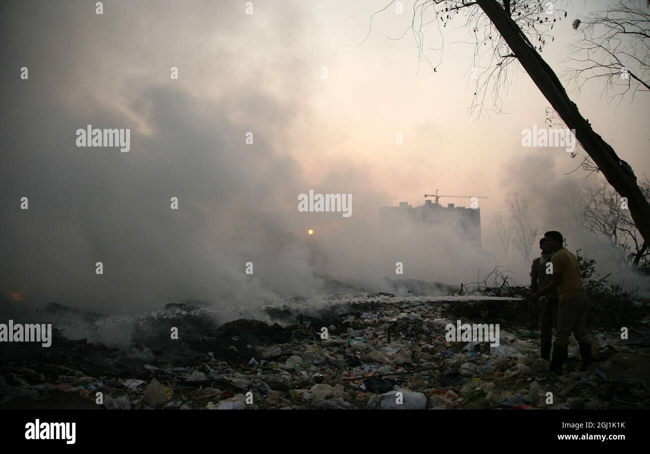 indian fire personnel try to douse the fire at a waste dumping ground ...