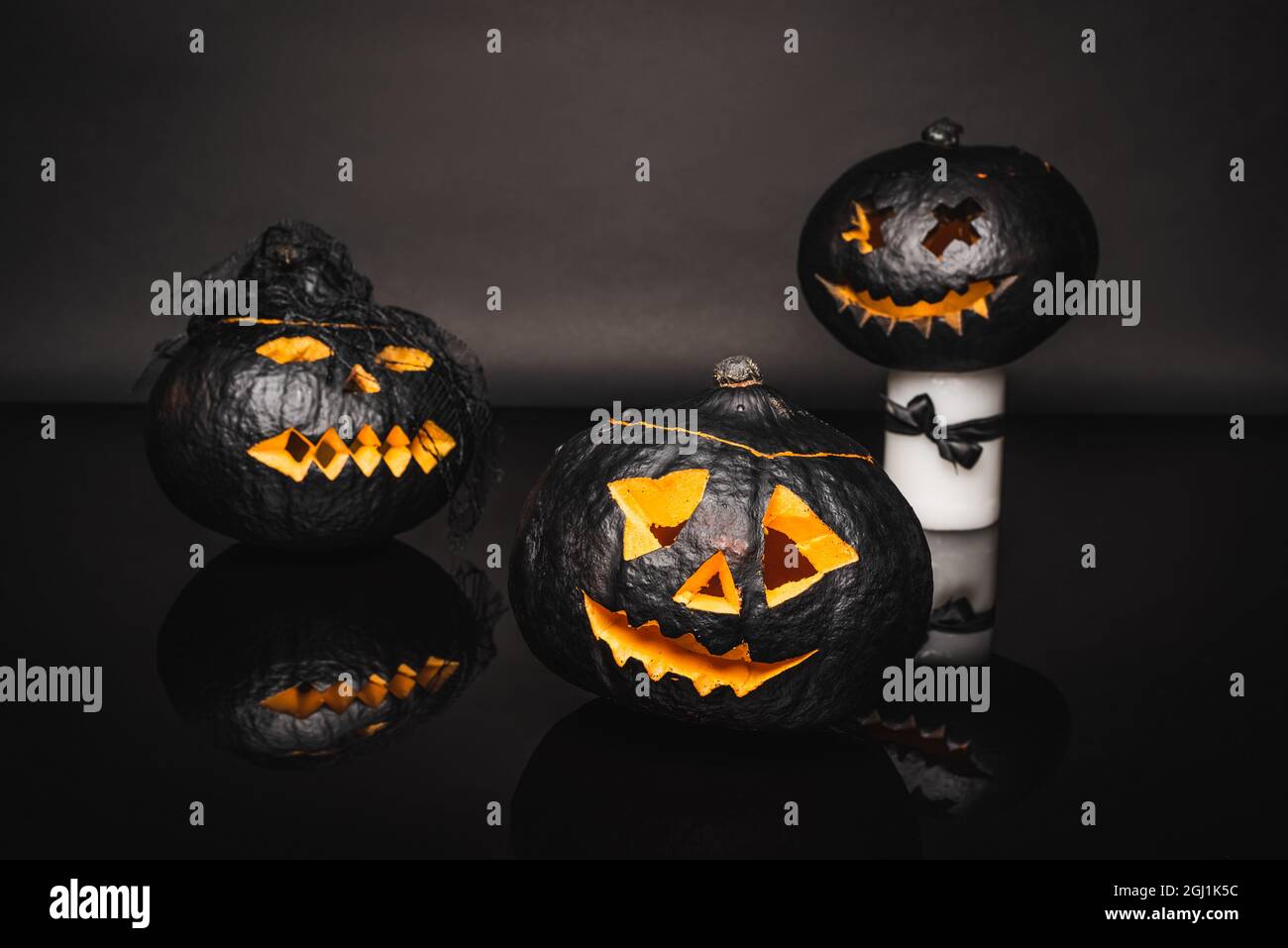 creepy dark and curved pumpkins on black Stock Photo - Alamy