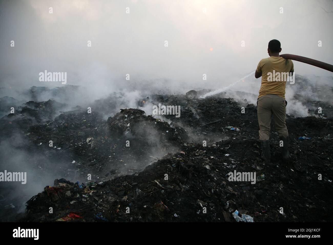 indian fire personnel try to douse the fire at a waste dumping ground ...