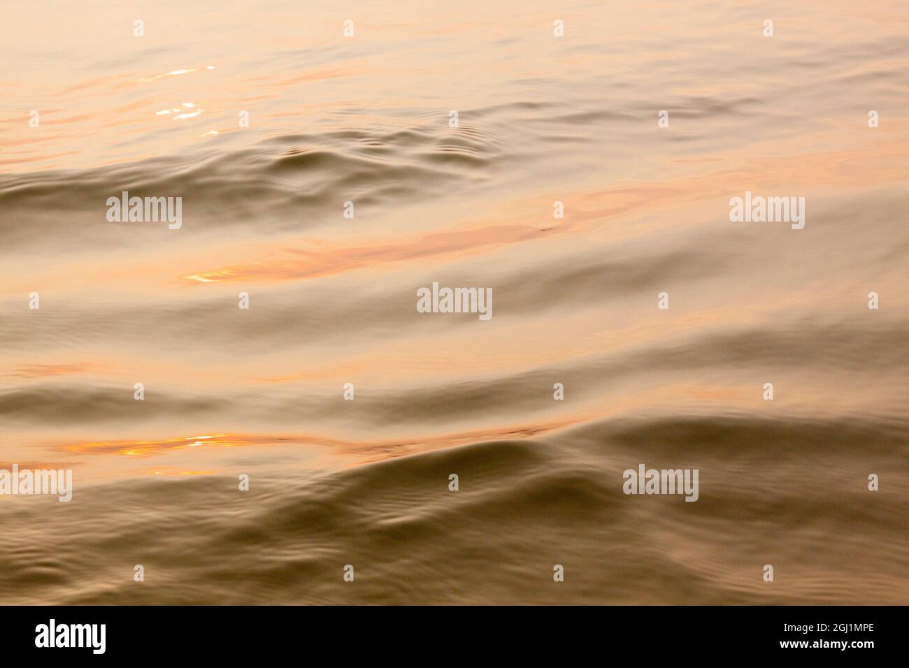 Orange and gold pattern on water Stock Photo - Alamy