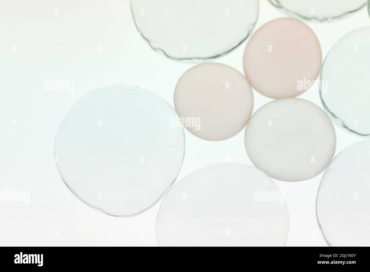 Clear Glass and Beige Glass Pebbles with light Stock Photo - Alamy