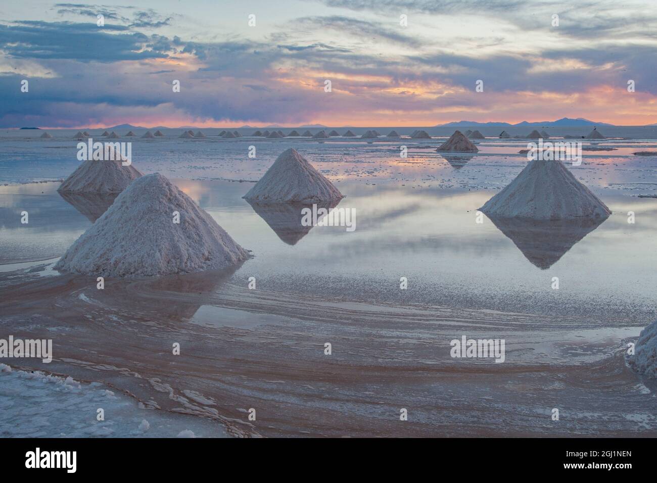 Bolivia, Uyuni, Salar de Uyuni. Cones of salt have been scraped up so ...