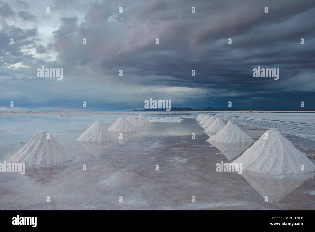 Bolivia, Uyuni, Salar de Uyuni. Cones of salt have been scraped up so ...