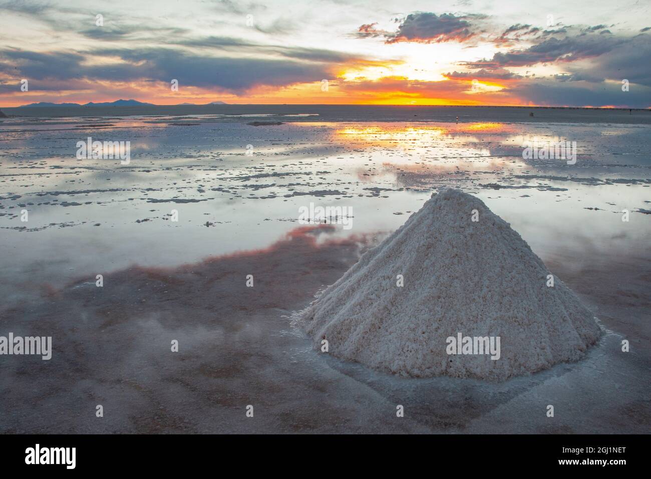 Bolivia, Uyuni, Salar de Uyuni. A salt cone sits in the water on the ...