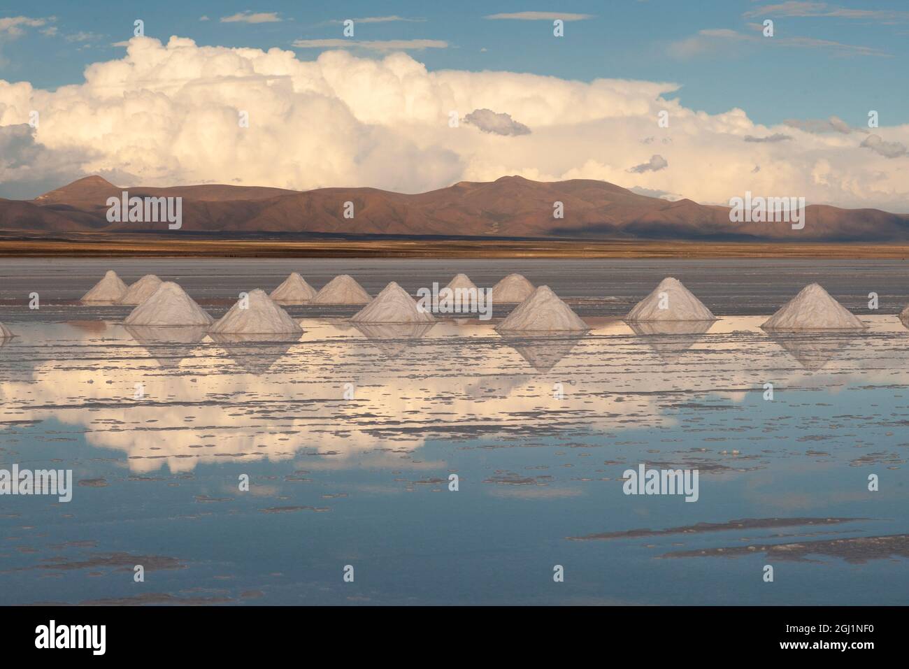 Bolivia, Uyuni, Salar de Uyuni. Cones of salt have been scraped up so ...