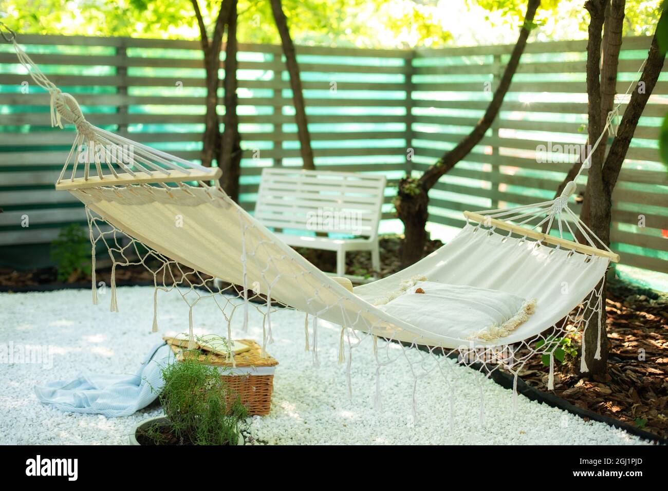 Cozy exterior backyard. Hammock in boho style hanging on tree. Concept ...