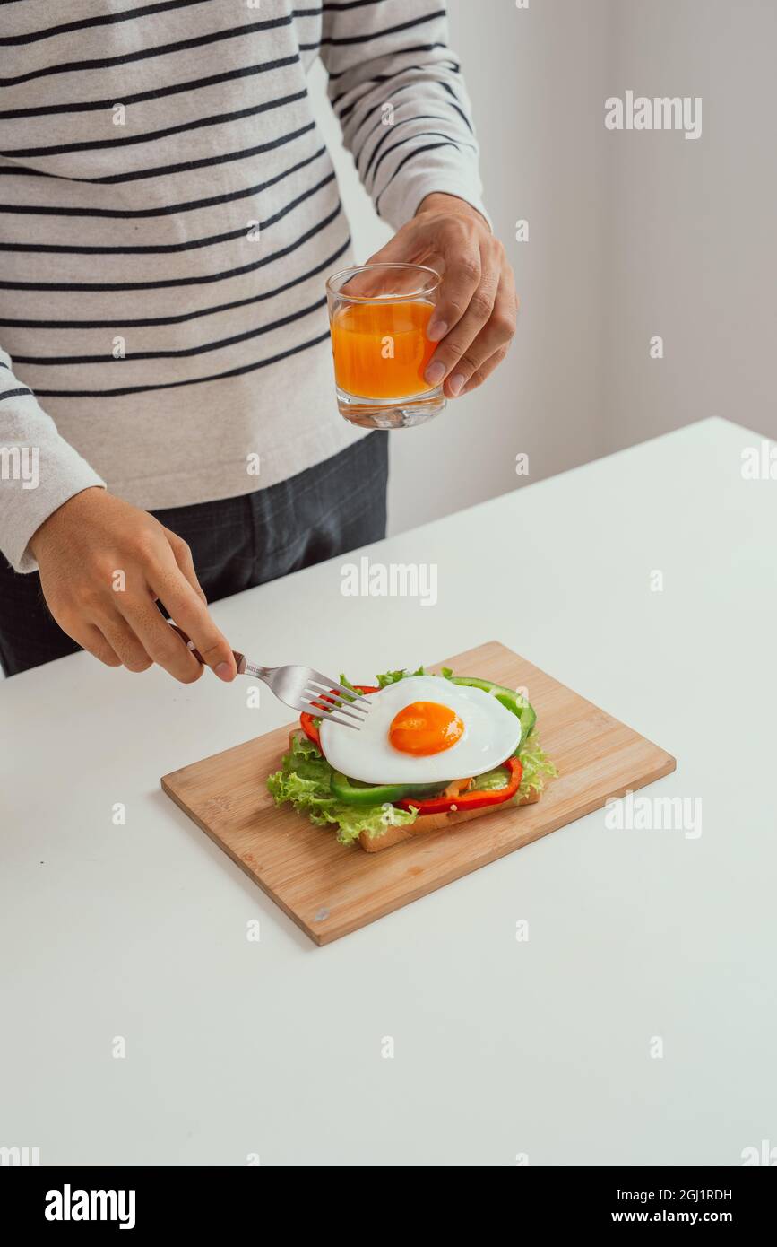Man eating sandwiches at home in the kitchen Stock Photo - Alamy