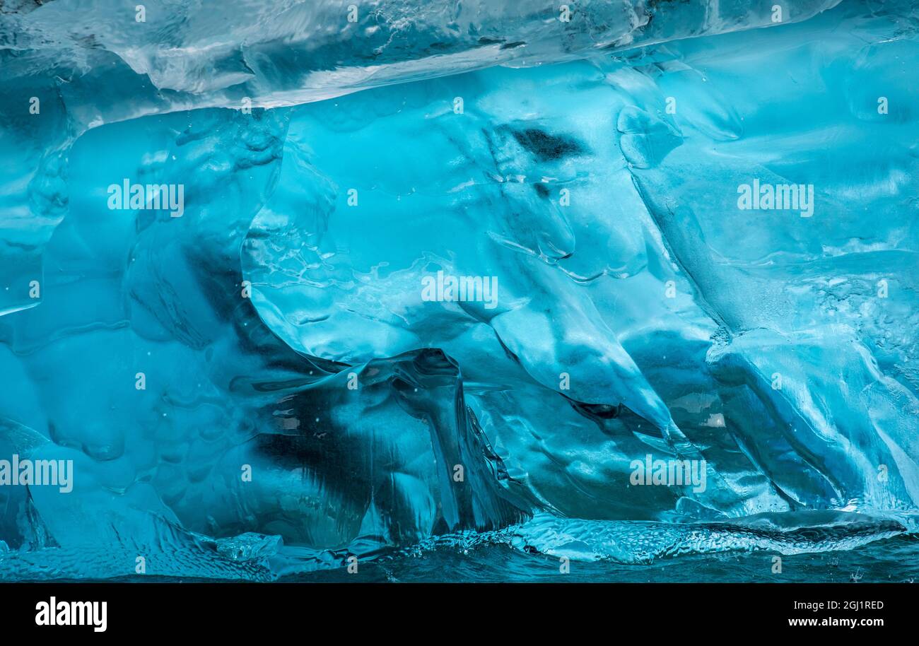 USA, Alaska, Close-up view of deep blue iceberg floating near calving ...