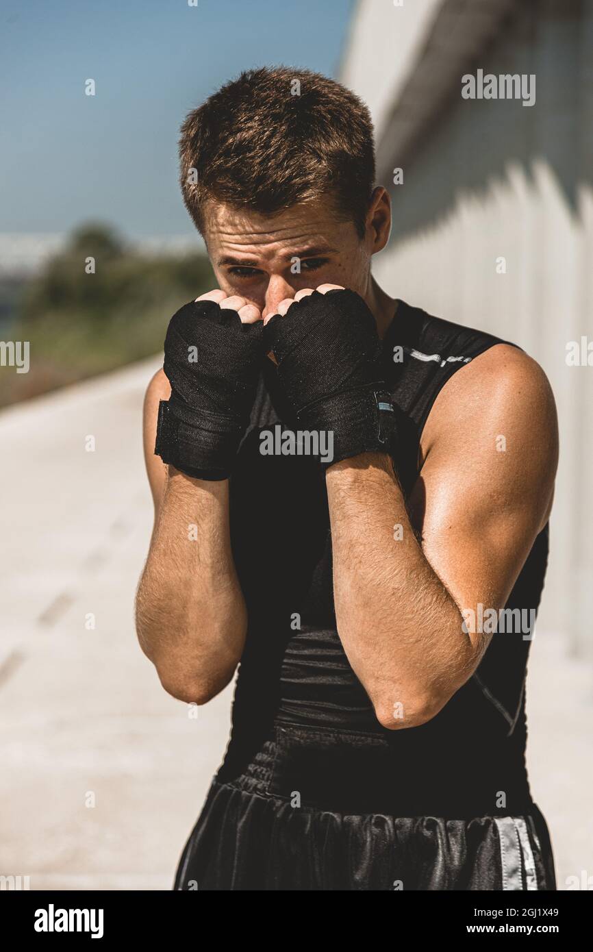 Man exercising and fighting in outside, boxer in gloves. male boxer ...