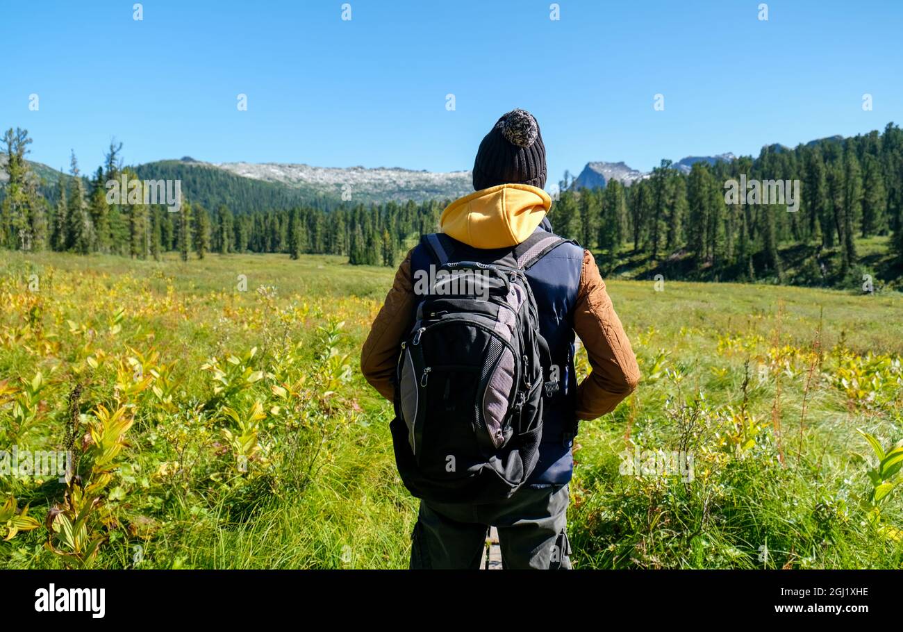 Tourist with backpack travelling to mountains Stock Photo - Alamy