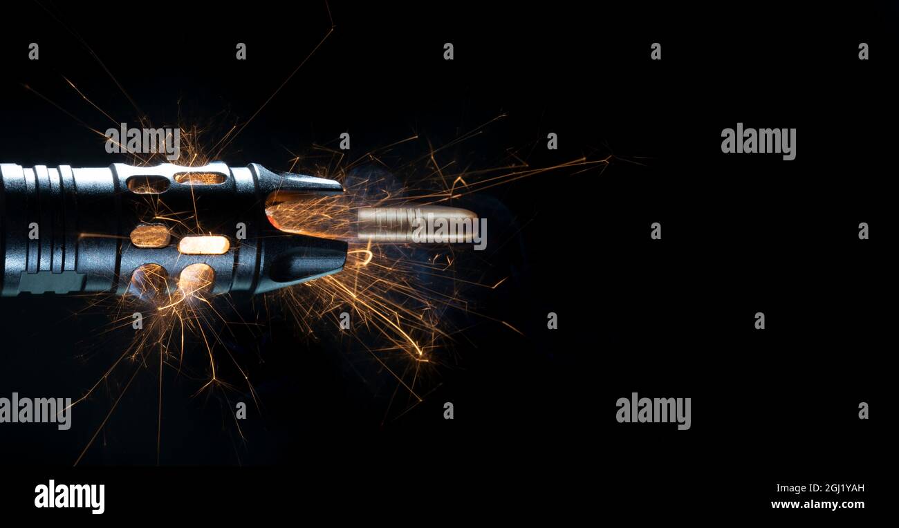 Copper bullet and sparks with smoke coming from the barrel of an ...