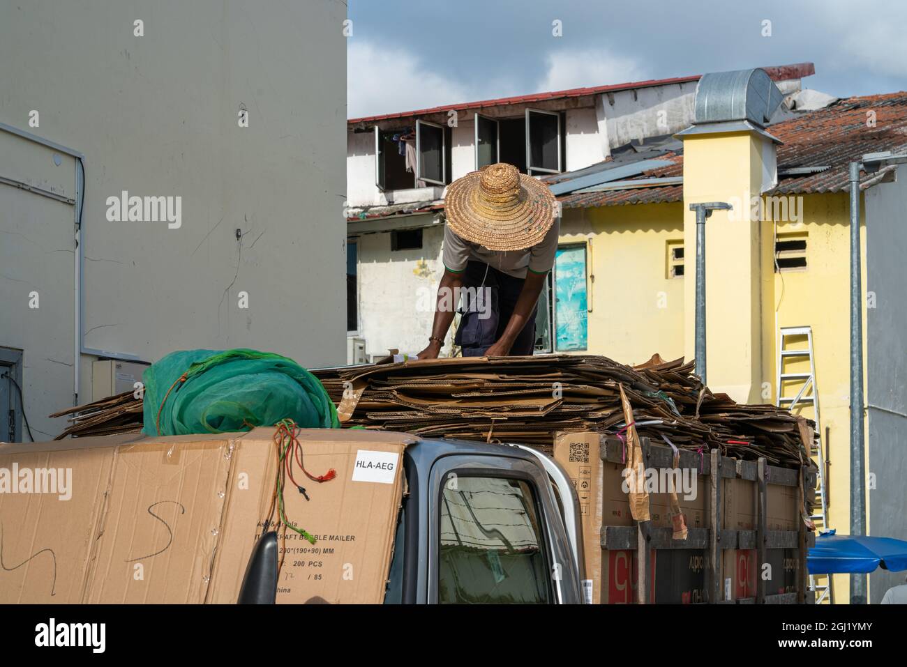 SINGAPORE, SINGAPORE - Sep 07, 2021: Man collecting carton boxes and ...