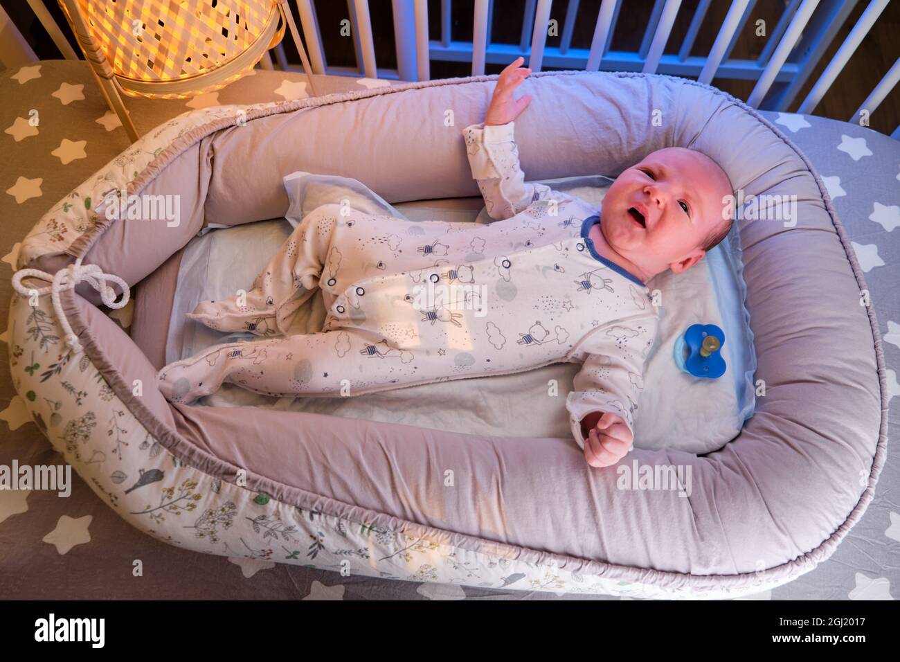 Baby lying in crib crying hi-res stock photography and images - Alamy