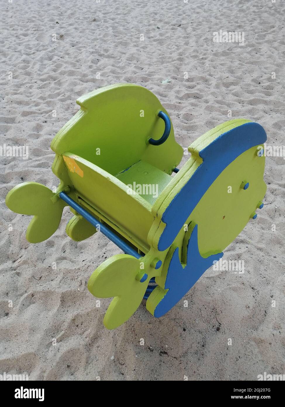 Yellow spring rider on the kid playground Stock Photo - Alamy