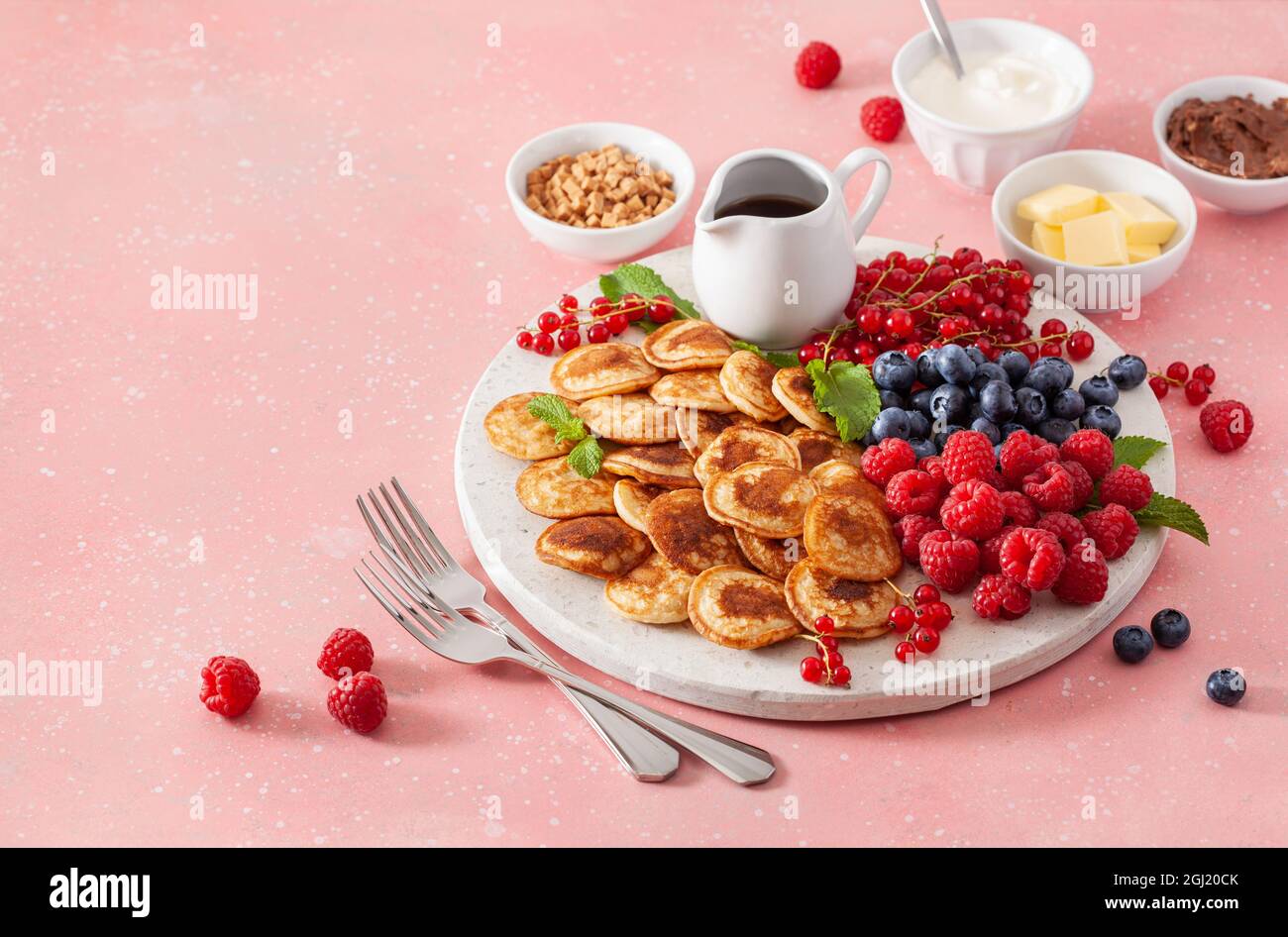 american mini pancake board with berries and maple syrup Stock Photo ...