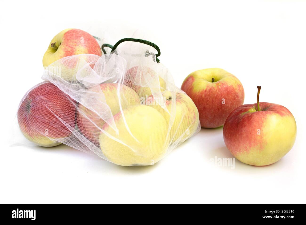 apples in a reusable bag on a white background Stock Photo - Alamy